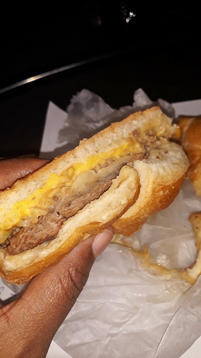 The money shot&mdash;a perfectly constructed slider revealing its secrets. The cheese doesn't just top the patty; it becomes one with it.