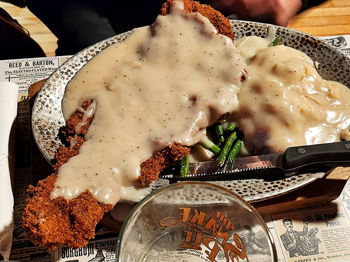 Chicken fried steak swimming in creamy country gravy&mdash;comfort food so good it might just heal whatever ails you, served on vintage-inspired dishware.