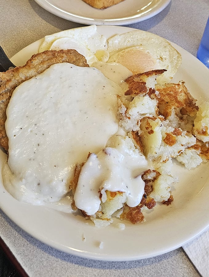 This isn't just country fried steak&mdash;it's a gravy-laden raft sailing atop a sea of perfectly crisped hash browns and sunny eggs.