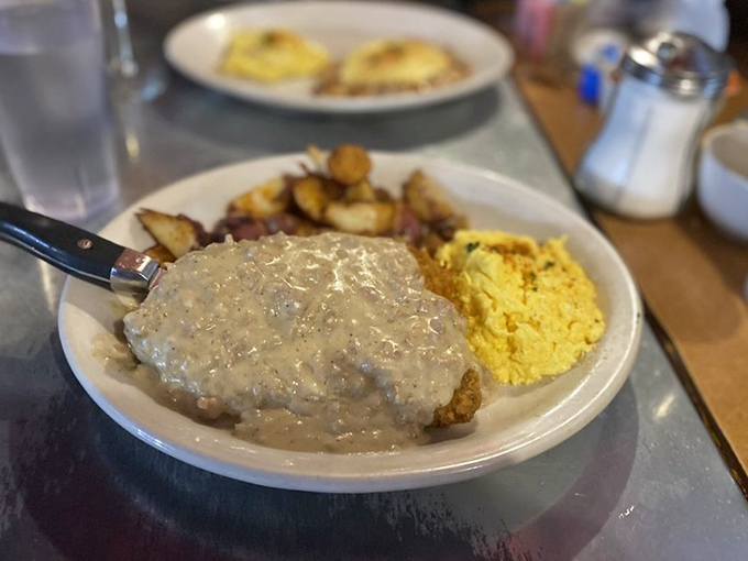Country gravy cascading over potatoes like a savory waterfall. Comfort food that hugs your soul on a chilly Idaho morning.