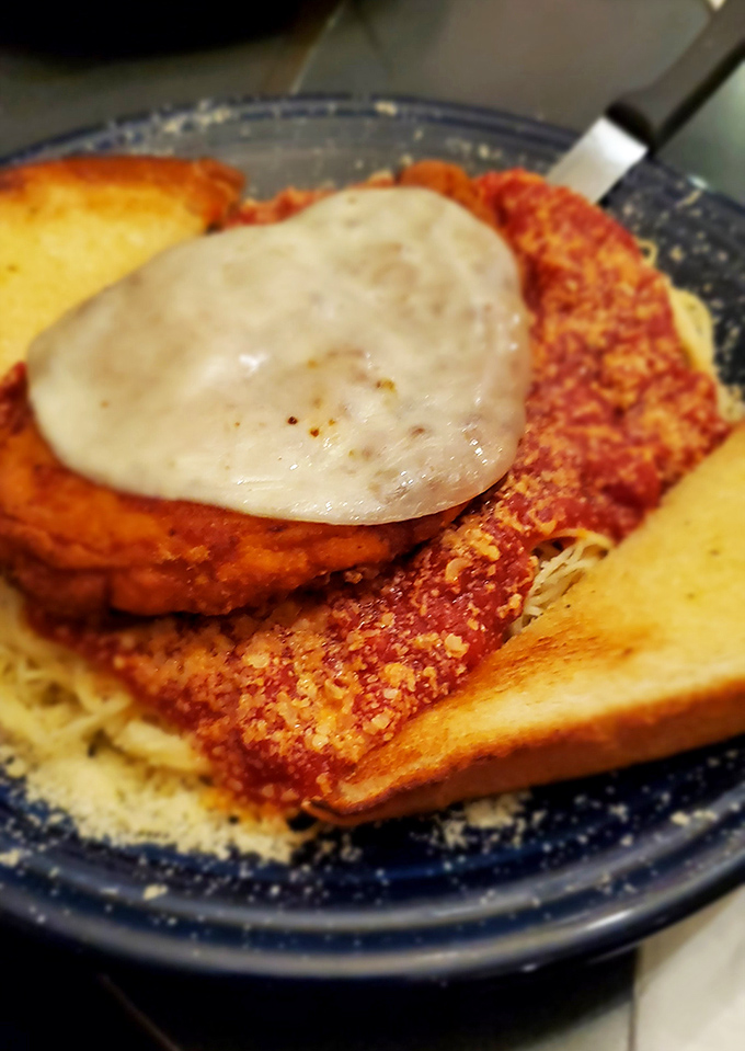 Chicken Parmesan that would make any Italian grandmother nod in approval, nestled on a bed of pasta that's calling your name.