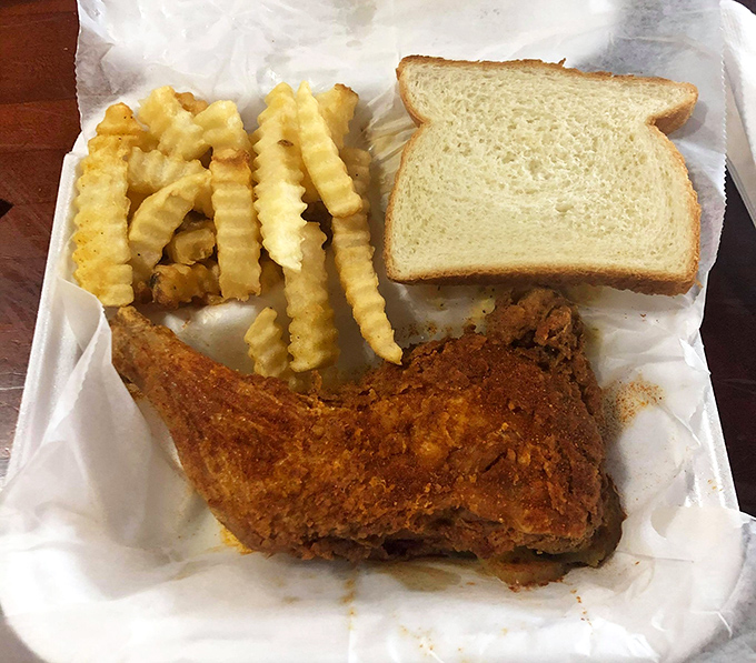 Simple white bread serves as the humble throne for royalty&mdash;crispy, golden hot chicken with cooling pickles standing guard against total spice domination.