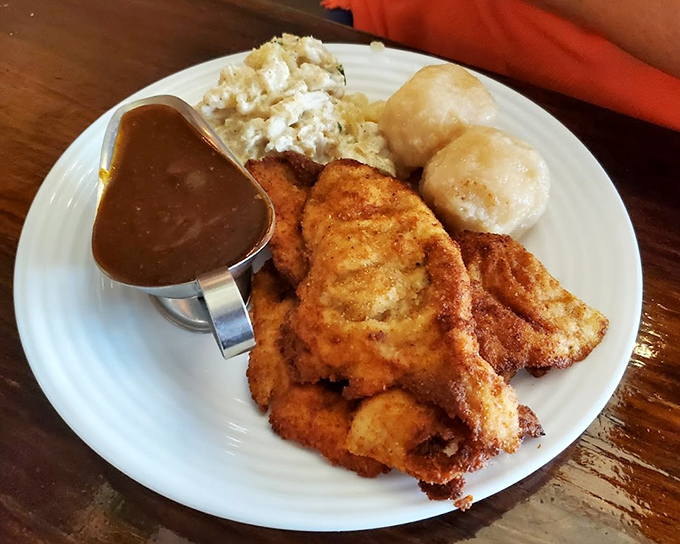 Breaded chicken schnitzel with potato dumplings and German potato salad proves some traditions should never change or be messed with.