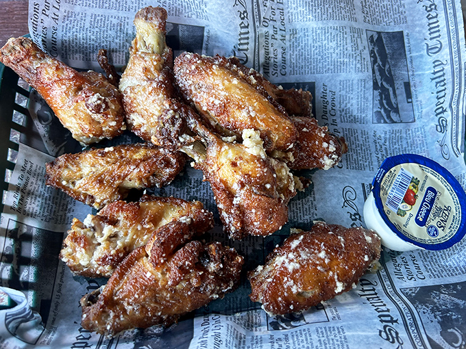 Garlic parmesan wings that could make Buffalo, NY jealous &ndash; crispy, aromatic, and served with zero pretension on yesterday's newspaper.