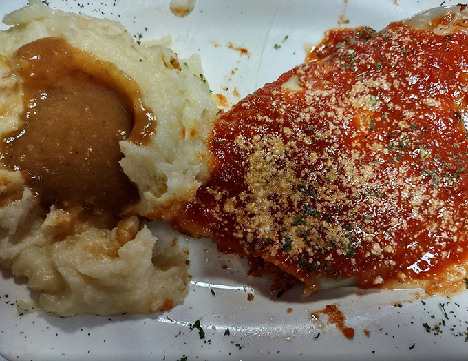 Comfort food perfection: creamy mashed potatoes with gravy alongside a generous portion of homestyle chicken parmesan. Pure Llanerch satisfaction on a plate.