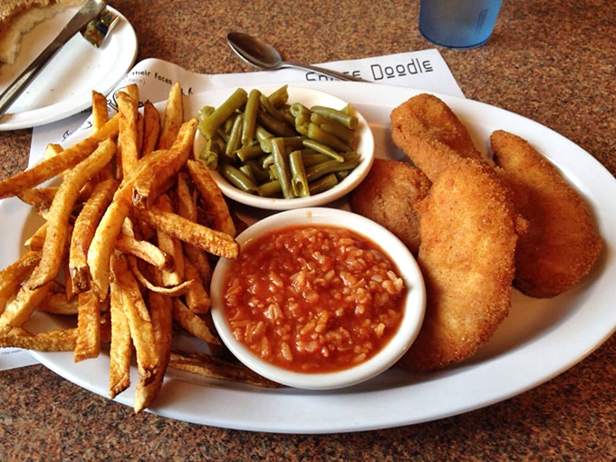 Crispy, golden perfection meets hot sauce and fries. This plate isn't trying to win a beauty pageant&mdash;it's aiming straight for your soul.