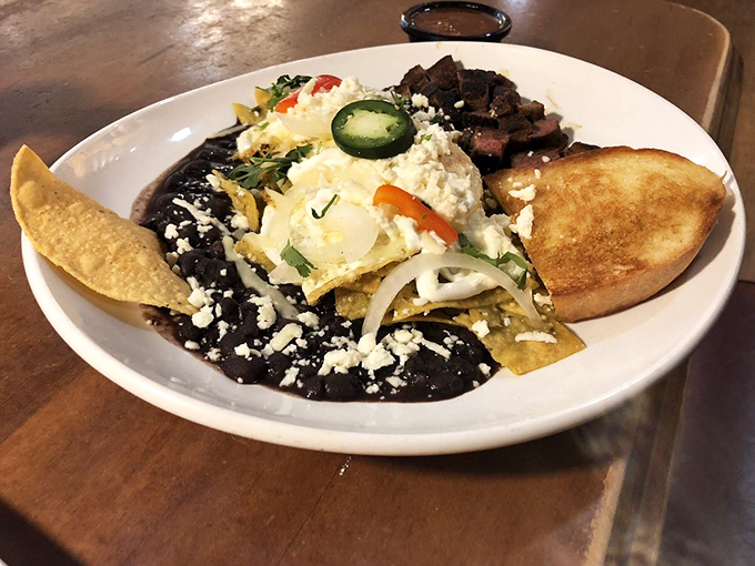 These chilaquiles verdes aren't just breakfast—they're an argument for abandoning the alarm clock and making brunch an everyday affair.
