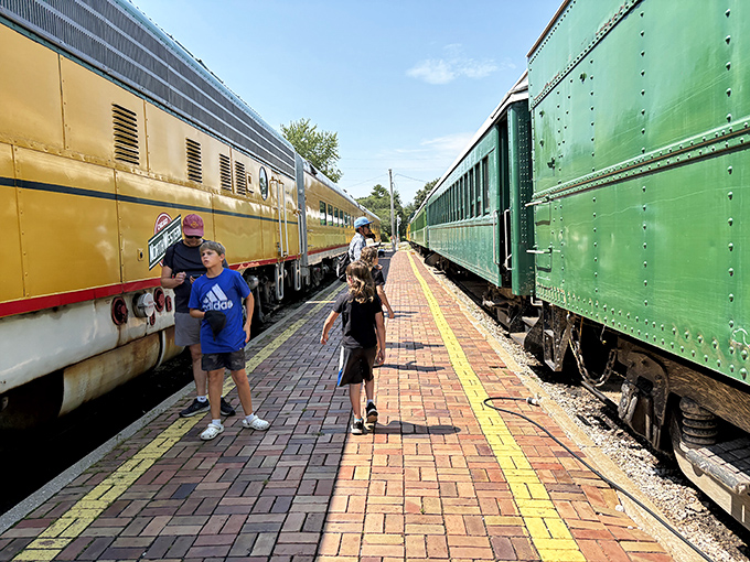 The platform between trains becomes a magical space where young explorers discover the scale and grandeur of these iron giants.