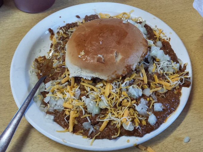 The chili burger arrives like a delicious disaster zone&mdash;the bun barely visible beneath an avalanche of meaty chili and cheese.