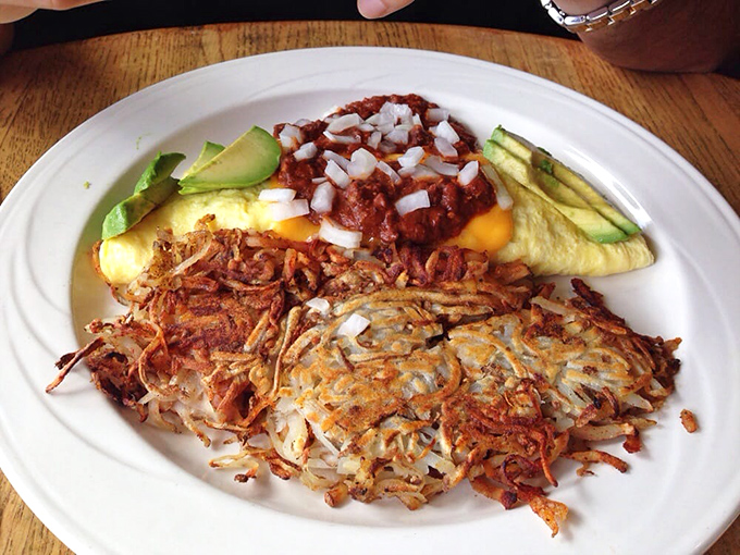 Huevos rancheros that doesn't skimp on any element &ndash; crispy hash browns, perfectly cooked eggs, fresh avocado, and salsa that looks like someone's grandmother made it.