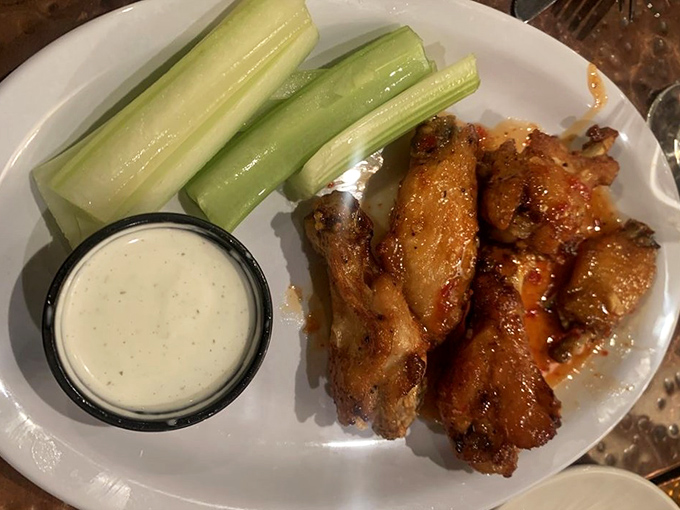 These wings aren't flying anywhere except straight to your taste buds. Crispy, saucy, and served with cooling celery sticks—medieval meets modern.