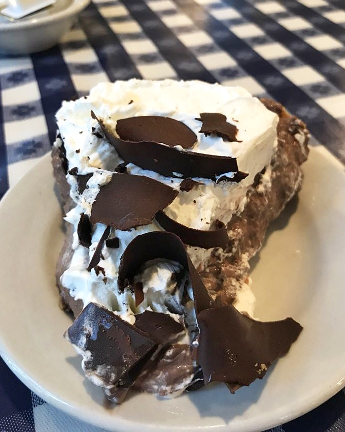 A slice of chocolate cream pie that doesn't just satisfy your sweet tooth&mdash;it throws a party for it. Those chocolate curls are wearing tiny dessert tuxedos.