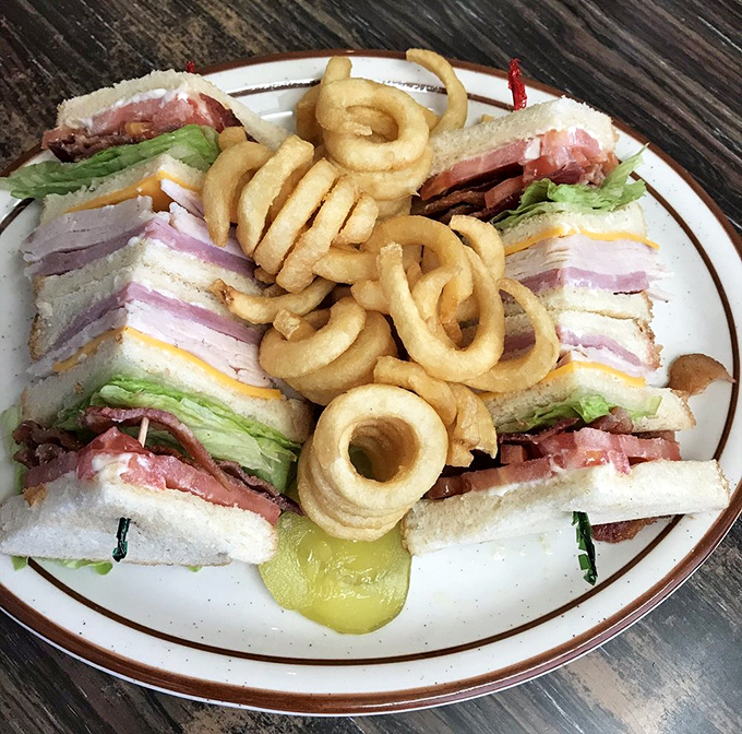 This isn't just a club sandwich&mdash;it's a skyscraper of comfort requiring architectural engineering and a healthy appetite to conquer.