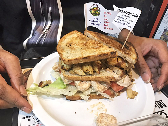 Some sandwiches make promises they can't keep. This towering club sandwich delivers a skyscraper of ingredients that requires both hands and a strategy.