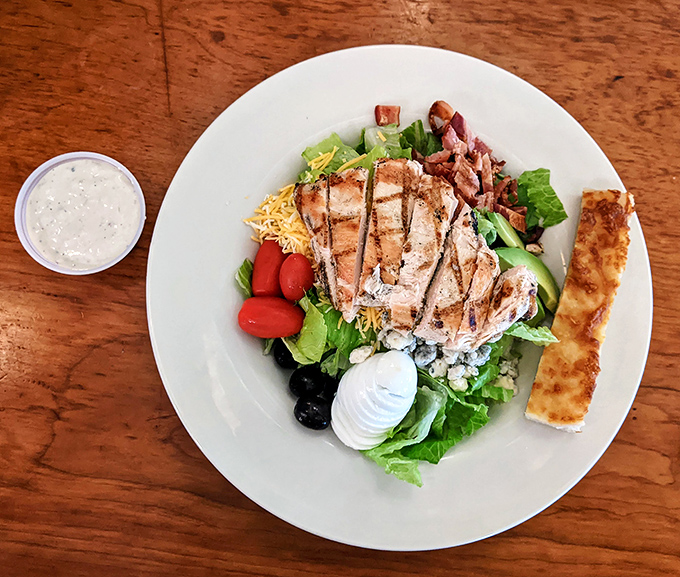 This Cobb salad brings serious game with grilled chicken, crispy bacon, and enough toppings to satisfy any appetite.