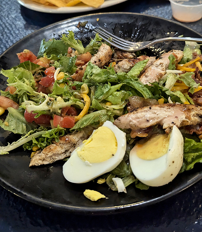 A salad that doesn't apologize for being delicious. Hard-boiled eggs and grilled chicken prove that "eating healthy" and "eating happy" aren't mutually exclusive concepts.