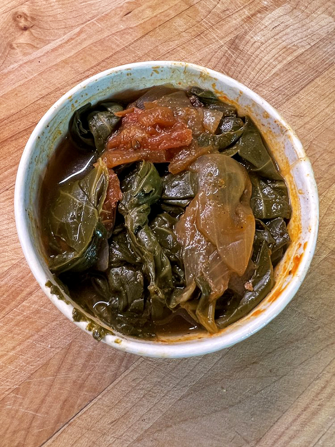 Soul in a bowl: these collard greens, slow-cooked with smoky depth and vinegary tang, might just upstage the chicken. Almost.