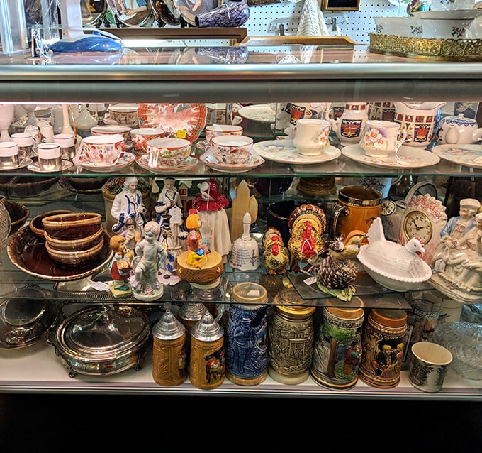 Behind glass, generations of teacups, figurines, and steins wait patiently for their second act in someone's curated collection.