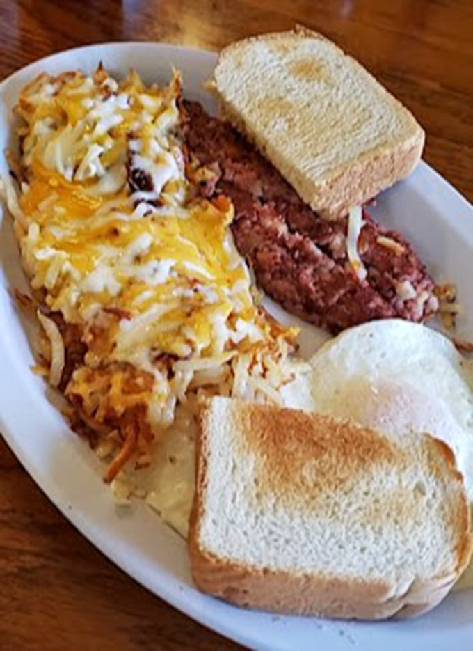 Breakfast alchemy at its finest: corned beef hash topped with melted cheese and eggs, with toast standing by for yolk-sopping duty.