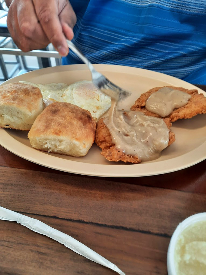 Country fried steak smothered in gravy alongside biscuits that deserve their own ZIP code. Comfort food that hugs you from the inside.