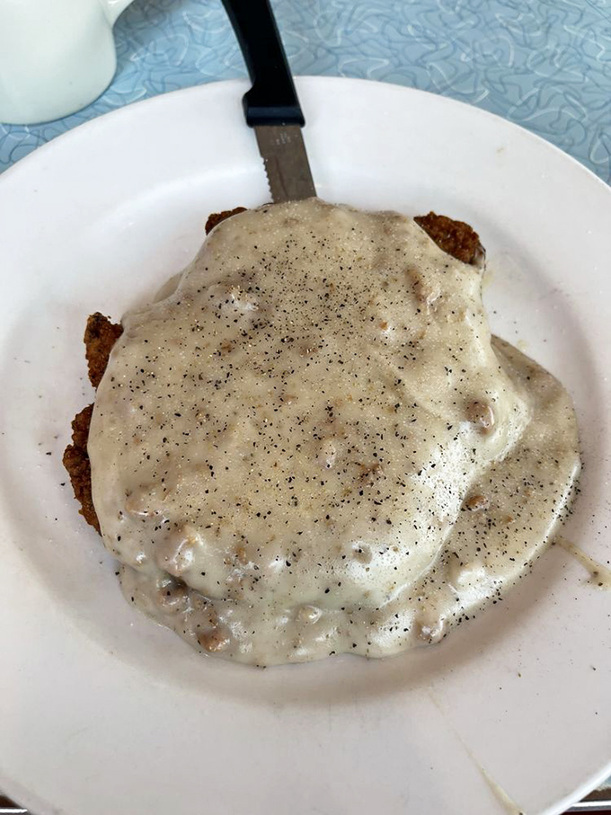 Country fried steak swimming in peppery gravy&mdash;the kind of dish that makes you want to hug the cook. Comfort food that speaks a universal language.