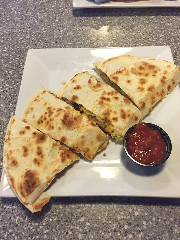 A quesadilla that doesn't understand the concept of moderation. Perfectly browned tortilla hiding a treasure chest of melty goodness.