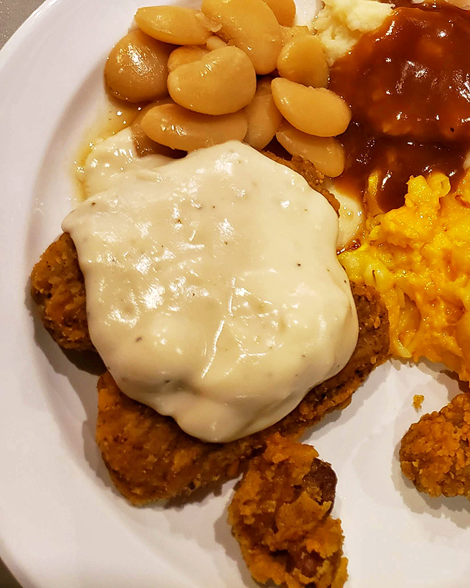 Country fried steak smothered in gravy &ndash; where Southern comfort food meets cardiac concern, and nobody's complaining about the introduction.