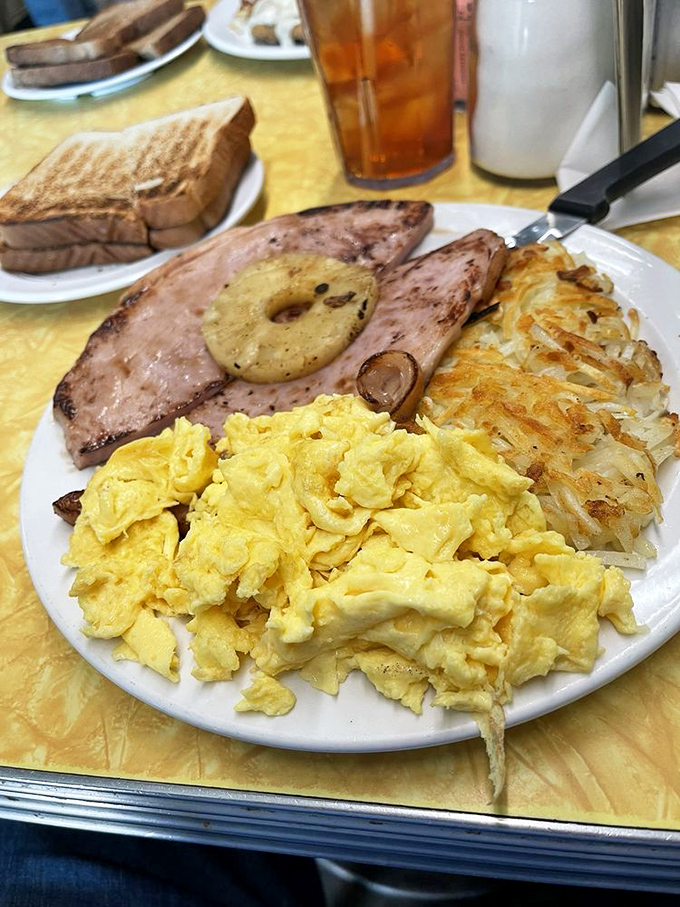 Ham, eggs, and hash browns—the holy trinity of diner breakfasts, executed with the precision that only comes from decades of practice.