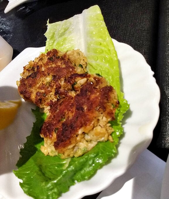 The crab cake here doesn't hide behind fillers&mdash;it proudly showcases sweet crab meat with a golden crust that audibly crackles.