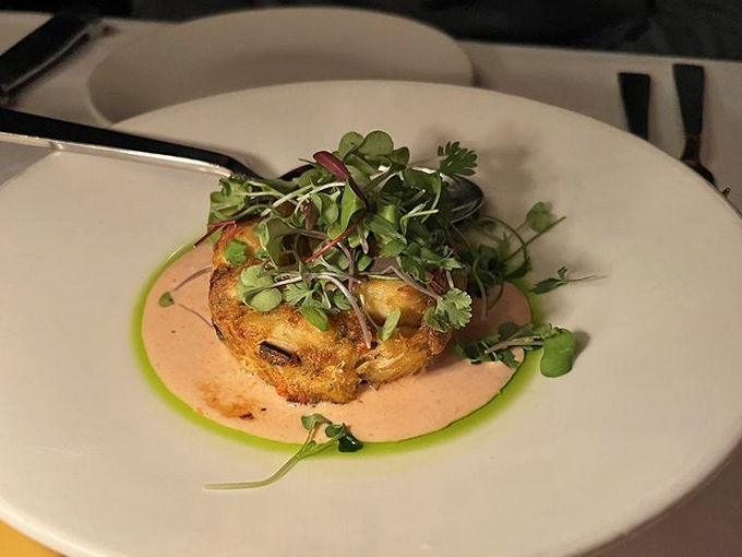 Delicate yet decadent, this crab cake perches on a pool of sauce like an island of seafood bliss waiting to be discovered.