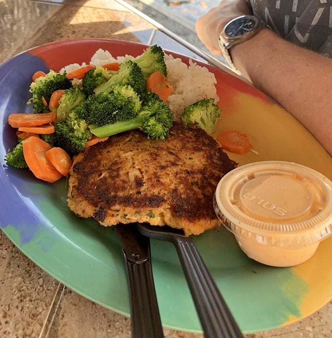 A golden-brown crab cake that doesn't hide behind fillers, served with fresh vegetables that remind you that healthy eating doesn't have to be punishment.
