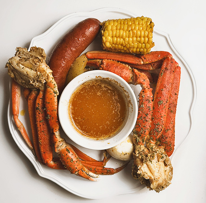Snow crab legs arranged like a sunburst around butter sauce&mdash;nature's perfect design meets culinary common sense.