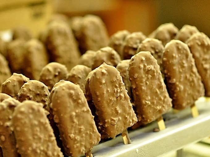 The chocolate-dipped crunch bars stand at attention like delicious soldiers, each one promising the perfect balance of smooth chocolate and satisfying crunch.