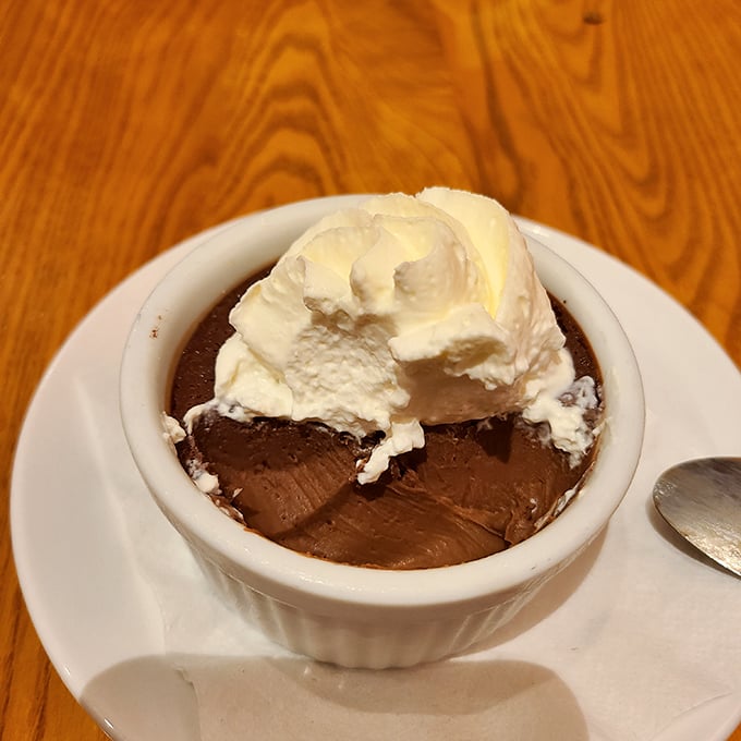 Chocolate custard with a cloud of whipped cream—proof that sometimes the simplest desserts create the most profound moments of silence at the table.
