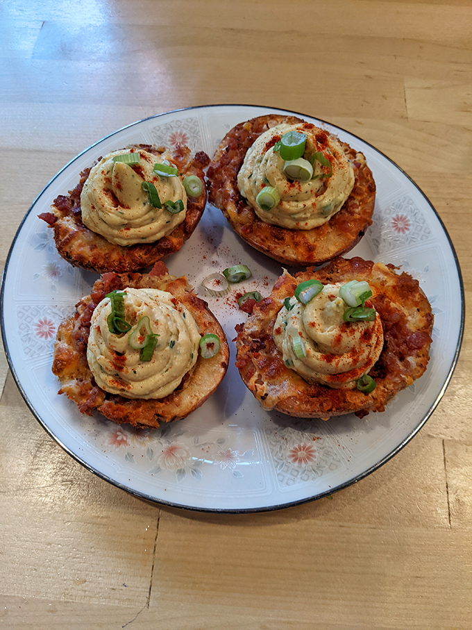 These deviled potato skins aren't just appetizers—they're little flavor bombs. The creamy topping and scallion garnish say "we don't do basic here."