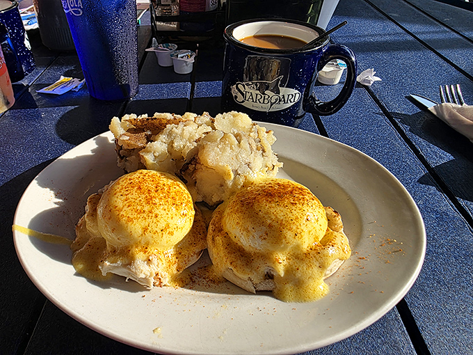 Eggs Benedict done right&mdash;two golden-domed poached eggs perched atop English muffins like royalty, crowned with hollandaise that practically glows in the sunlight.
