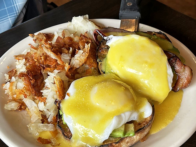 Eggs Benedict that achieves the holy trinity of breakfast perfection: runny yolks, crispy English muffin, and hollandaise that deserves its own fan club.