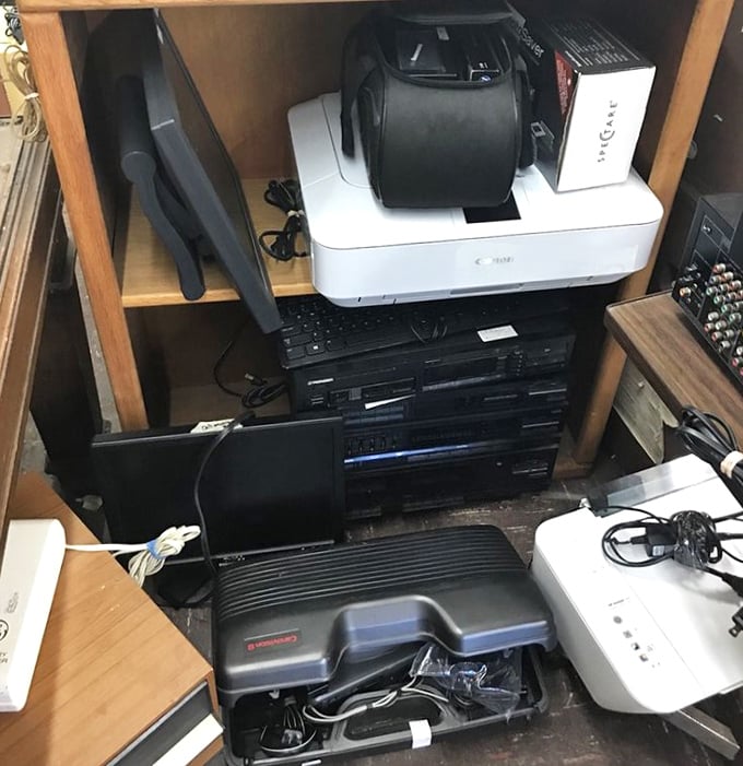 Technology's timeline captured on dusty shelves. Remember when these gadgets were cutting edge? Someone's obsolete electronics are another's vintage tech collection.