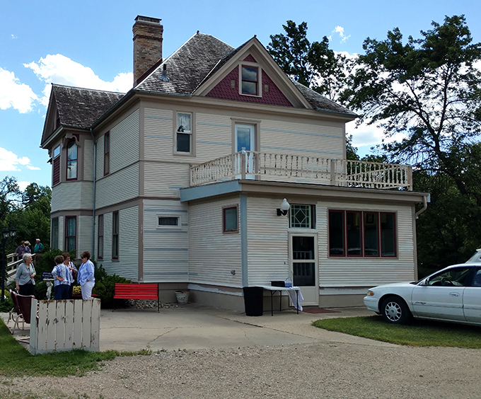 This historic home whispers stories of prairie prosperity, its wraparound porch practically begging for lemonade, conversation, and watching the world roll by.