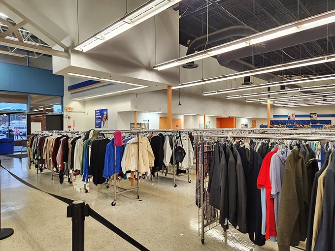 Beneath Goodwill's mission statement, racks of pristine white tops create an ironic blank canvas in a store full of colorful histories.