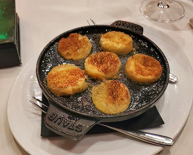 These escargot sizzle in their cast iron pan, each buttery, garlicky morsel waiting to transport you straight to a Parisian bistro.