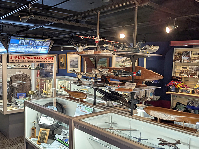 A treasure trove of aviation history displayed with loving care, where model aircraft hang like mechanical mobiles above glass cases of memories. 