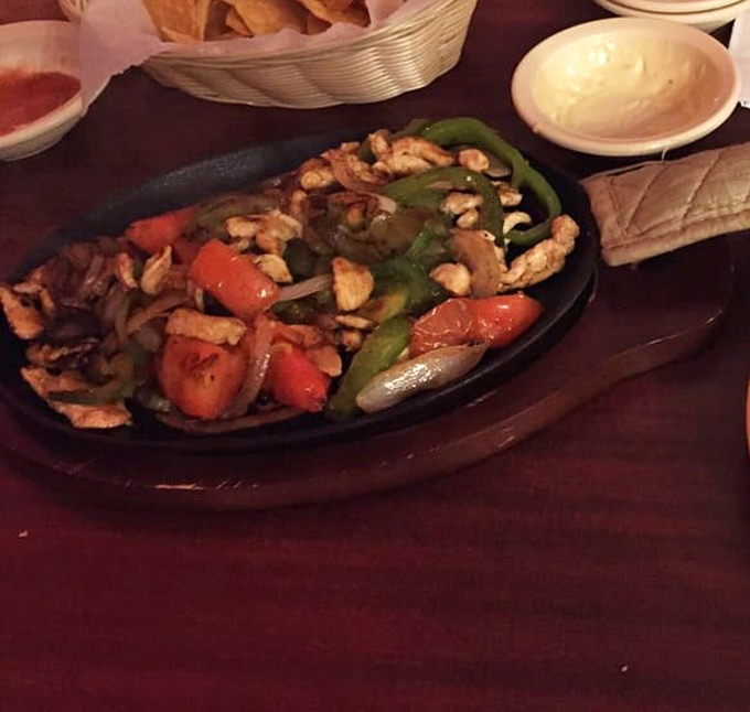Sizzling chicken fajitas that announce their arrival with a theatrical hiss and steam, making every head in the restaurant turn with food envy.