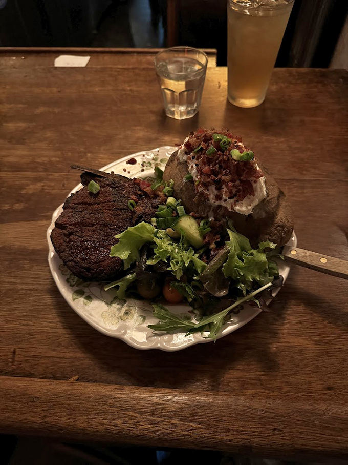 A perfectly grilled steak, a loaded baked potato, and a side salad&mdash;the holy trinity of steakhouse perfection that never goes out of style.