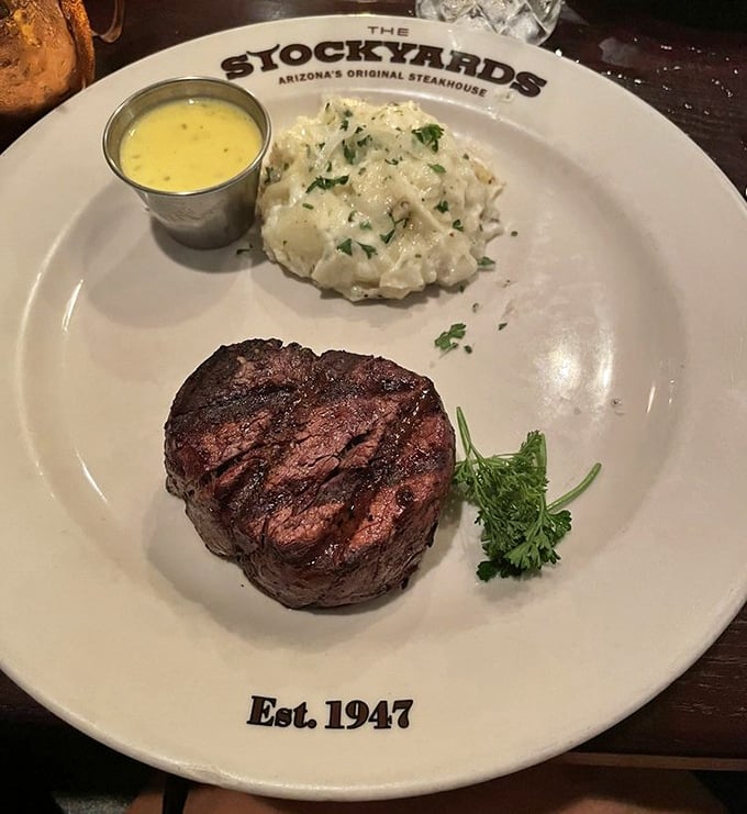 Filet mignon that could cut with a harsh glance, paired with potatoes that clearly went to finishing school. Simple perfection on a branded plate.