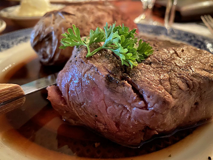 The filet mignon arrives like royalty, perfectly seared and crowned with a sprig of parsley—meat that's worth pledging allegiance to.