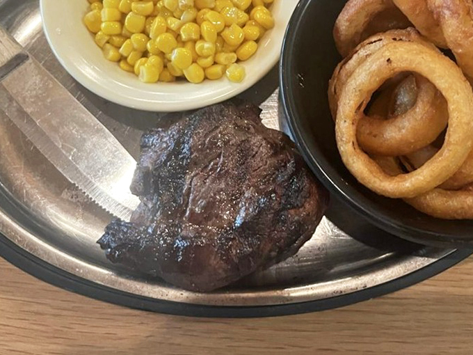 Simple pleasures: sweet corn, onion rings, and a steak that reminds you why humans discovered fire in the first place.