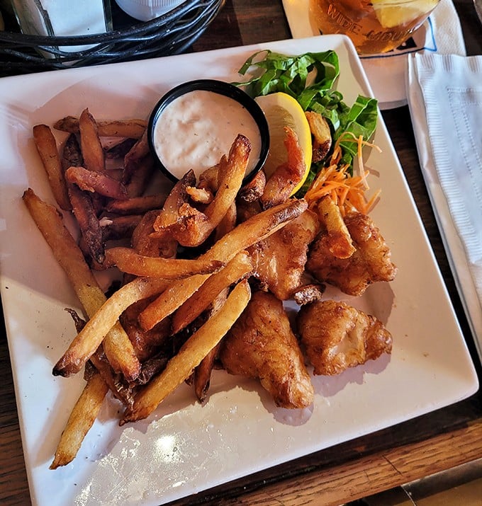 Crispy fish nestled beside hand-cut fries&mdash;a plate that whispers "Alaska" with every bite. The tartar sauce adds just the right tangy counterpoint.