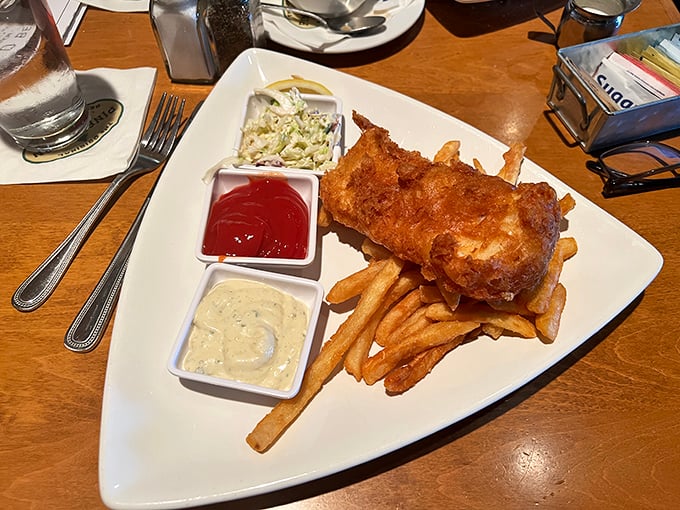 Fish and chips that would make coastal towns jealous, with a golden batter that shatters like delicate glass.