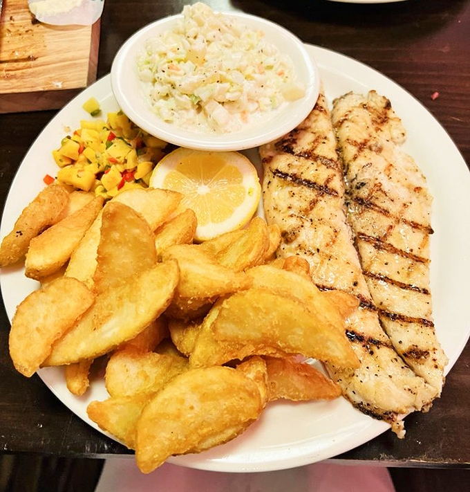 Not your average fish and chips&mdash;this plate boasts golden potato wedges and grilled fish that would make Captain Ahab hang up his harpoon and order seconds.